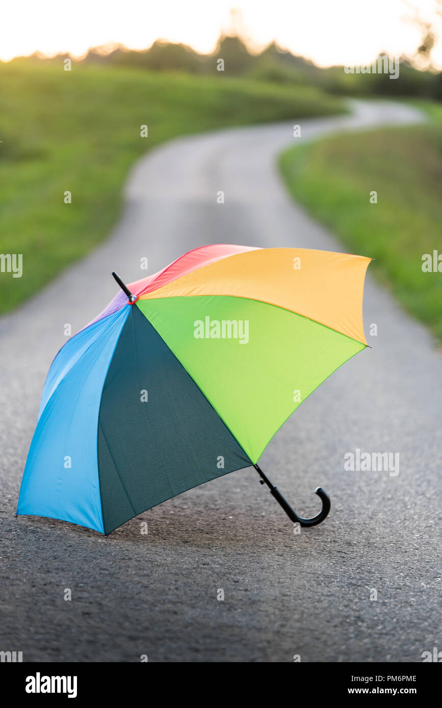 colorful umbrella on the country road Stock Photo - Alamy