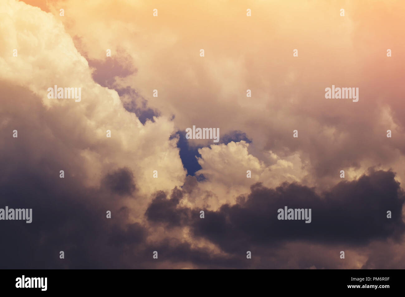 Nature background. Fluffy soft clouds in sky toned Stock Photo - Alamy