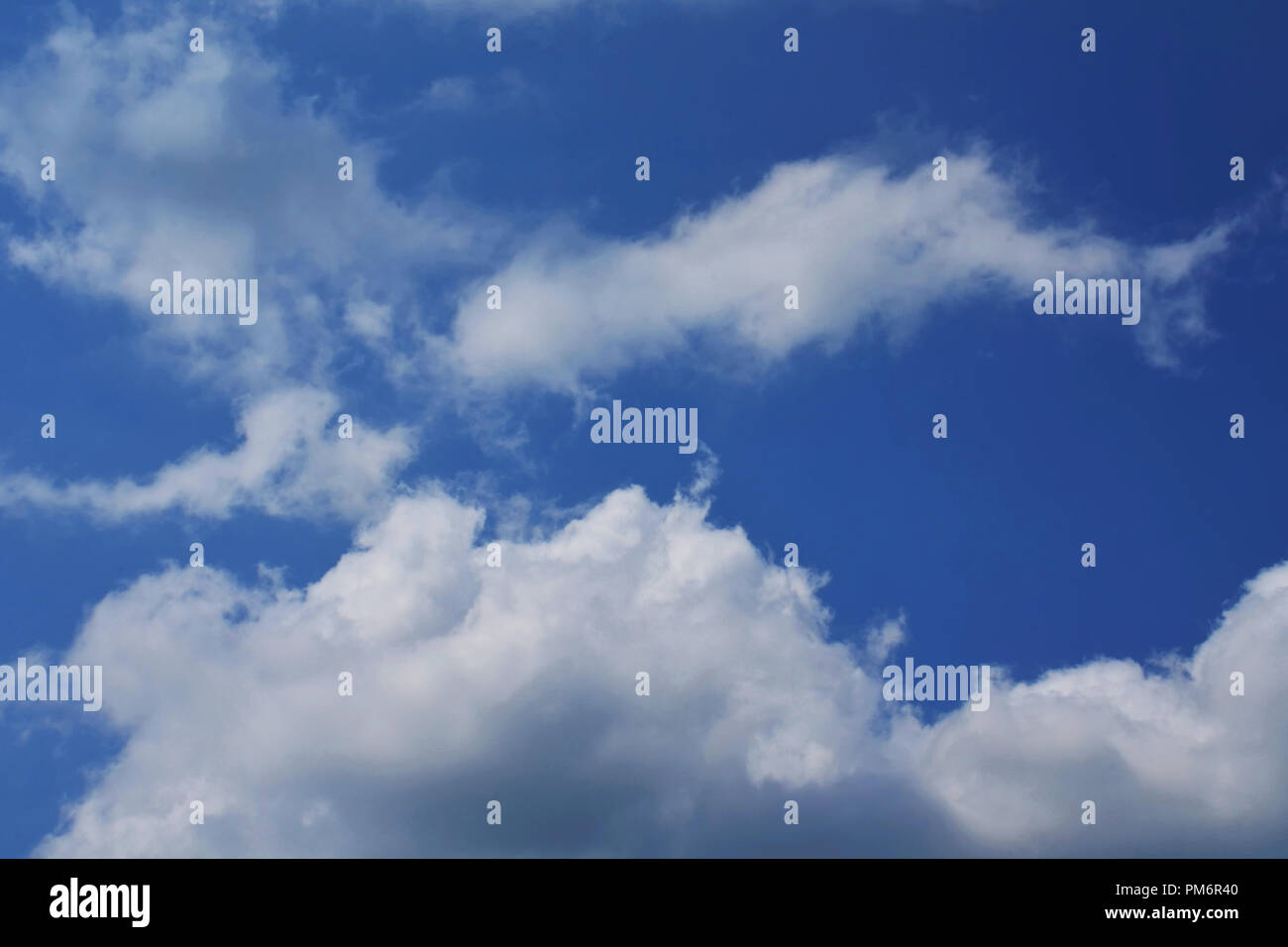 Nature background. Fluffy soft clouds in sky toned Stock Photo - Alamy