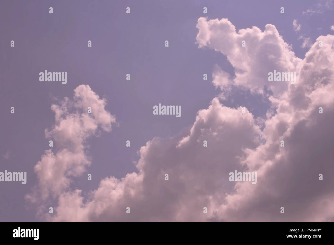 Nature background. Fluffy soft clouds in sky toned Stock Photo - Alamy