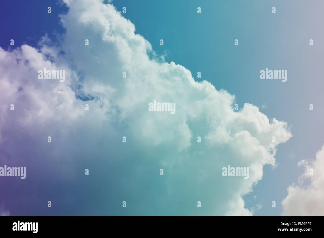 Nature background. Fluffy soft clouds in sky toned Stock Photo - Alamy
