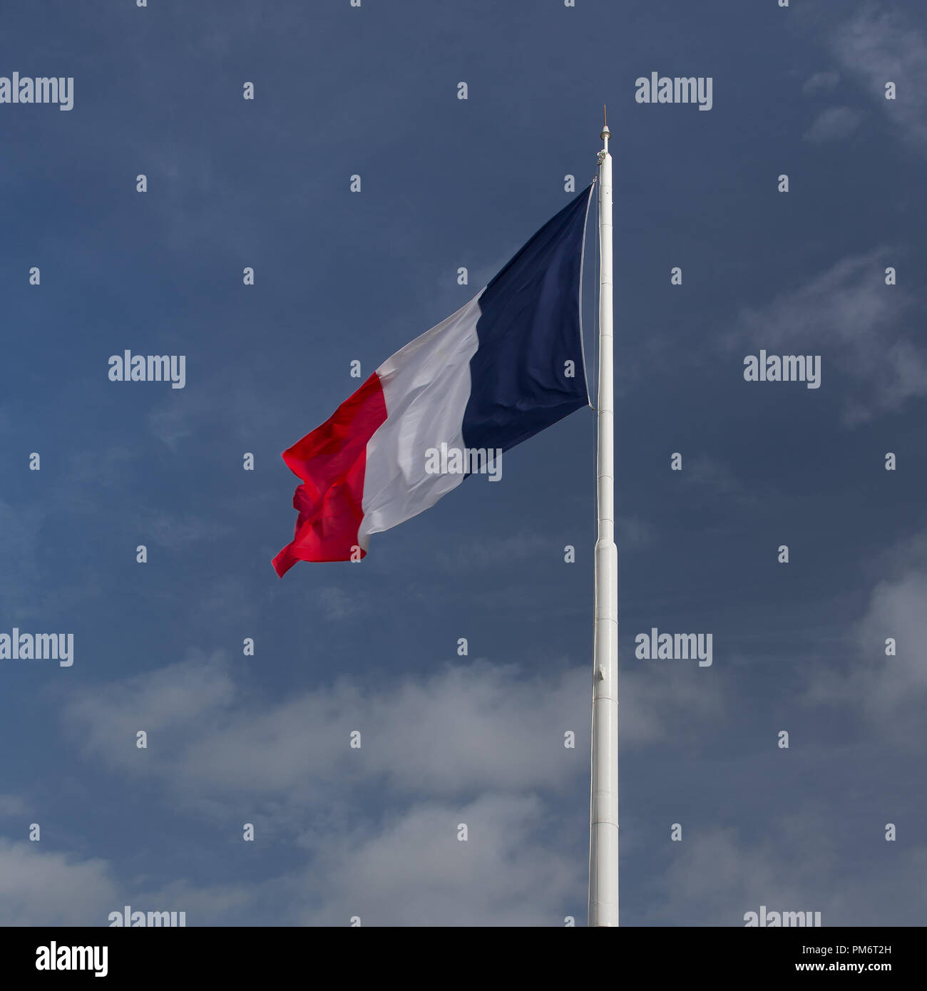 French flag flying against a sunny sky Stock Photo - Alamy