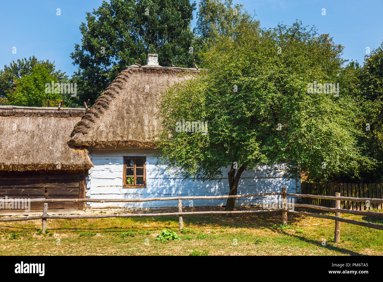 Old log house with thatched roof, traditional rural architecture in ...