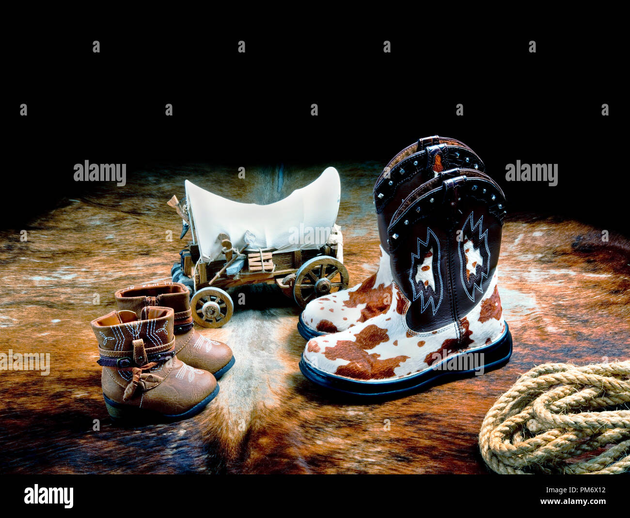 Cowboy boots,rope and western covered wagon with room for your type ...