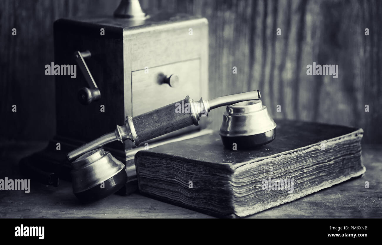 Old telephone and retro book on the desk. The phone of the past Stock ...