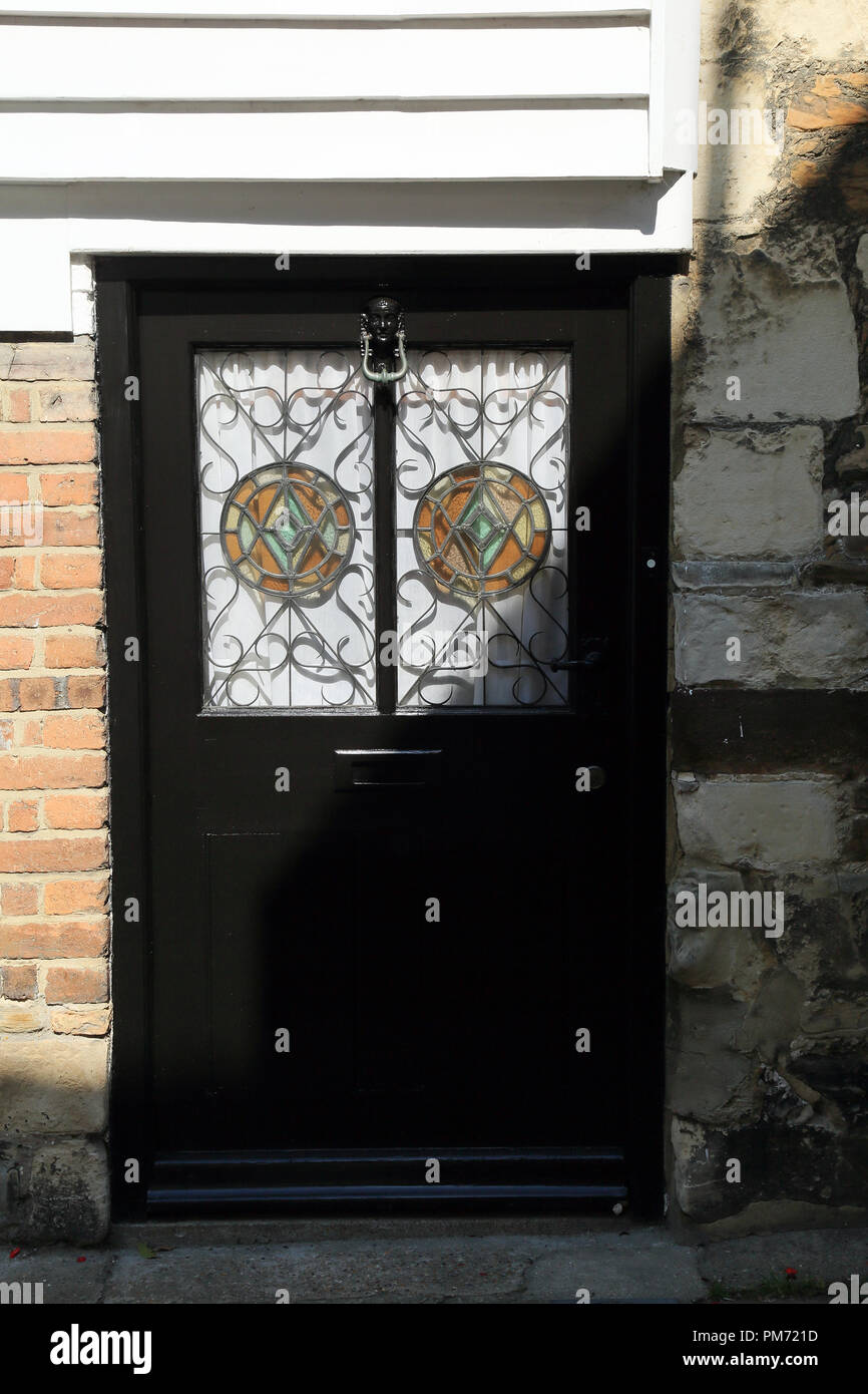Black door with decorative stained glass window in West Street, Rye, UK ...