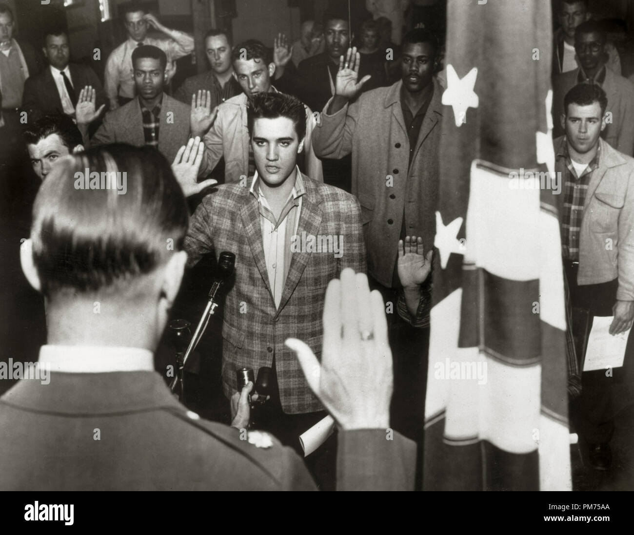 Elvis Presley being sworn into the United States Army by an officer ...