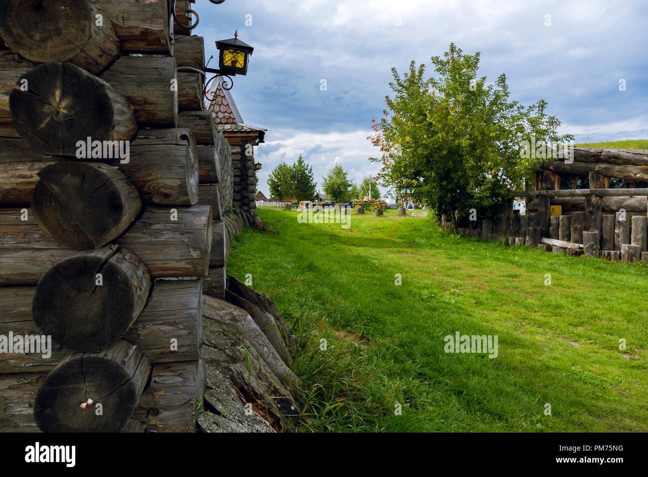 Angle of log cabin with suspended decorative lanterns with yellow ...