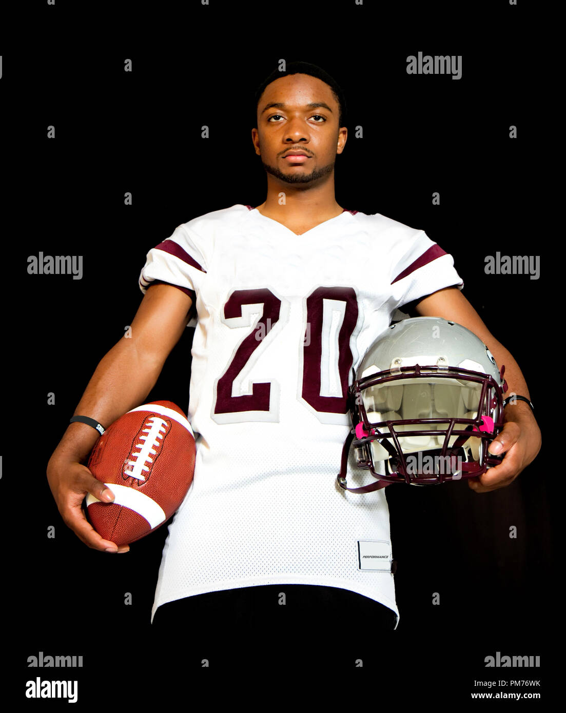 Senior High School Football player posing with football Stock Photo - Alamy