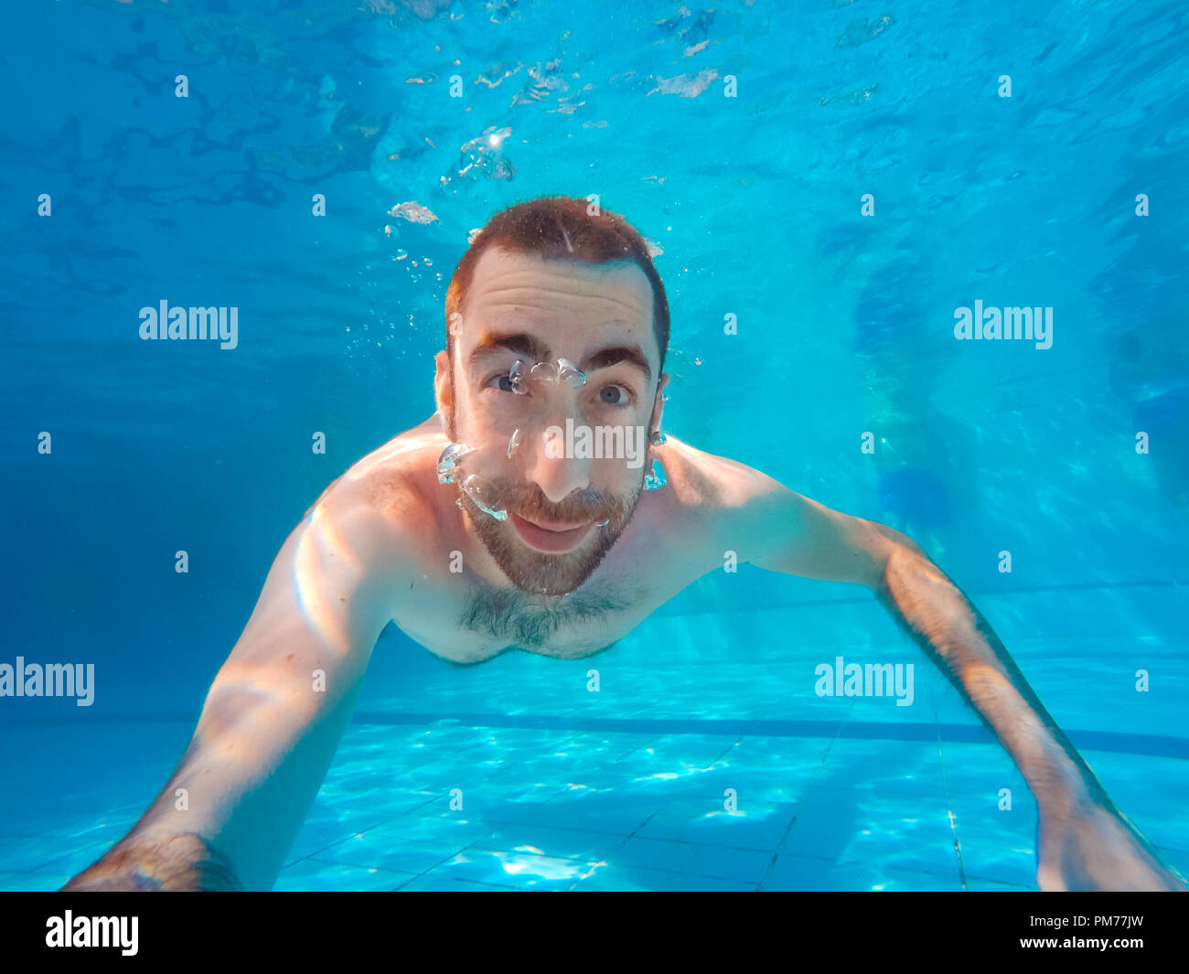 Young handsome man diving underwater in a swimming pool Stock Photo - Alamy