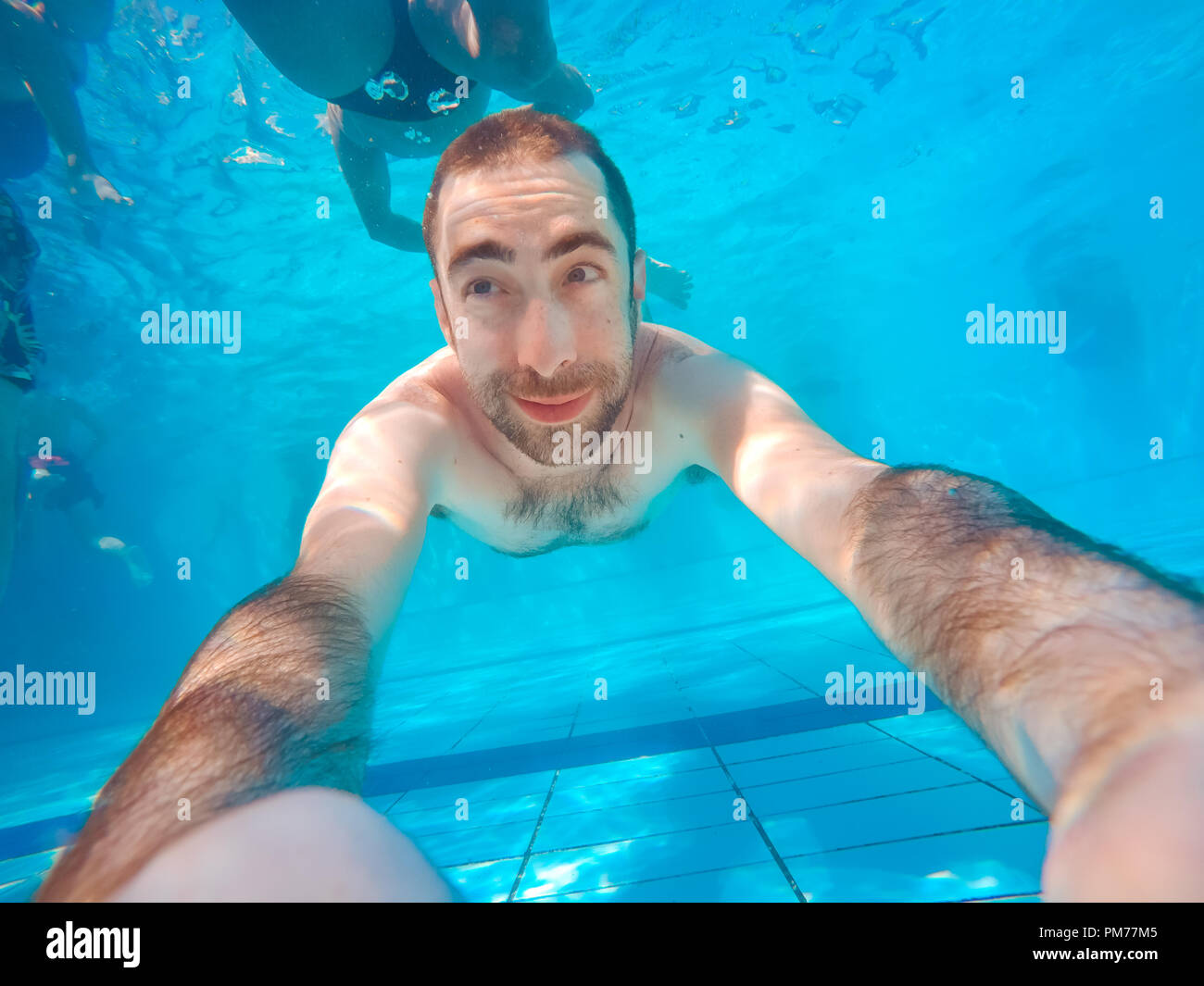 Young handsome man diving underwater in a swimming pool Stock Photo - Alamy
