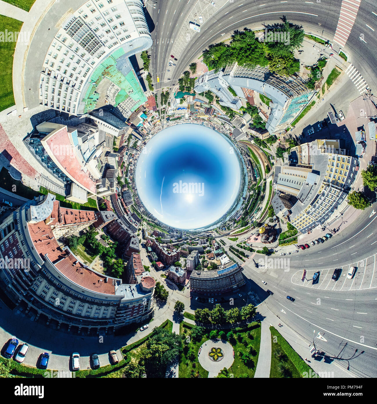 Aerial city view with crossroads and roads, houses, buildings, parks and parking lots. Sunny ...