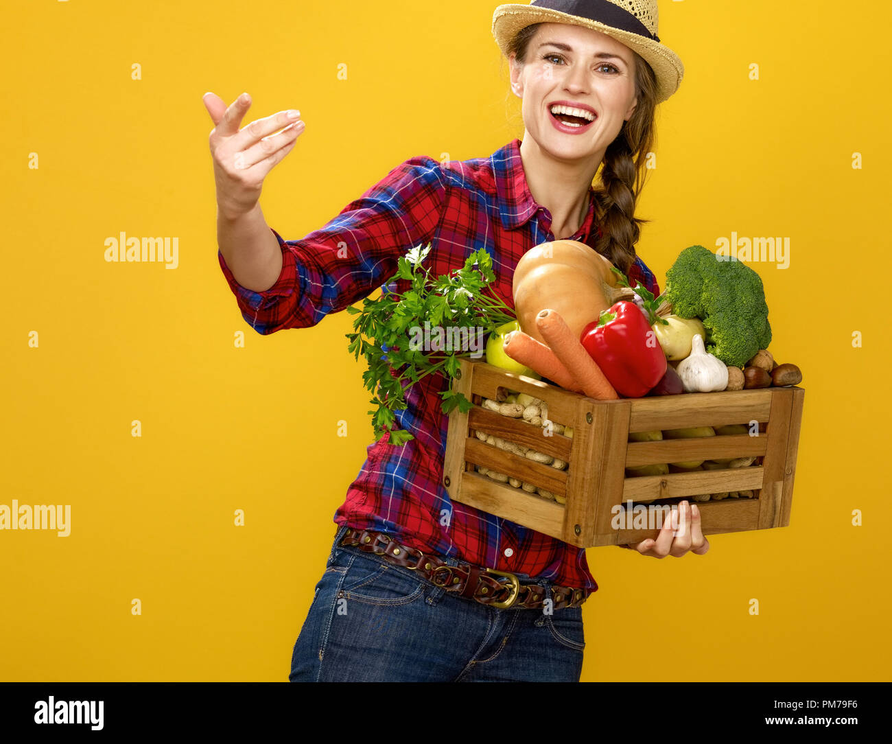 Healthy food to your table. smiling young woman grower in checkered ...