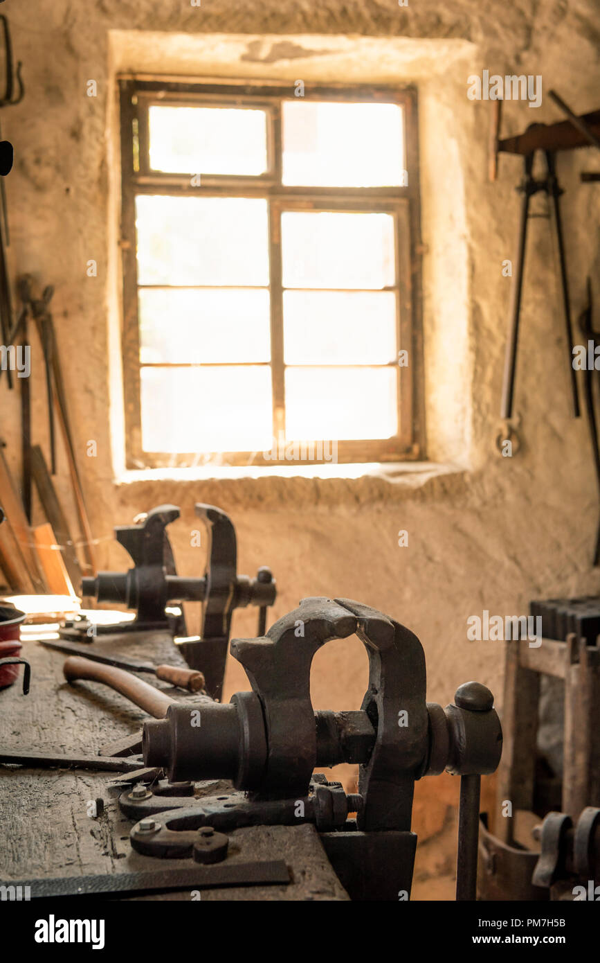 Interior image from a medieval blacksmith workplace with the two vices ...