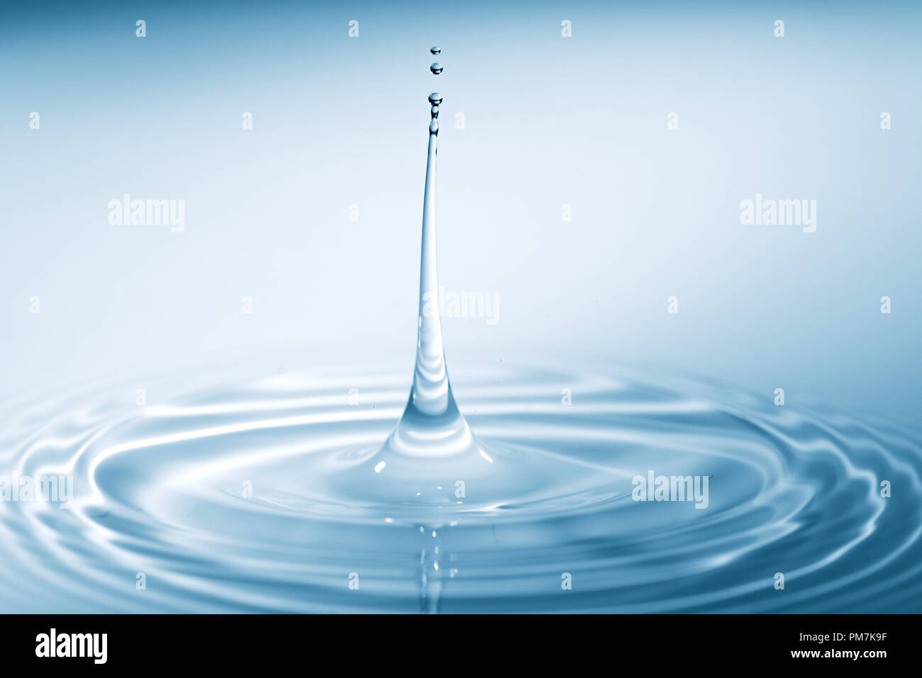 Water drop falling into water making a perfect droplet splash Stock ...