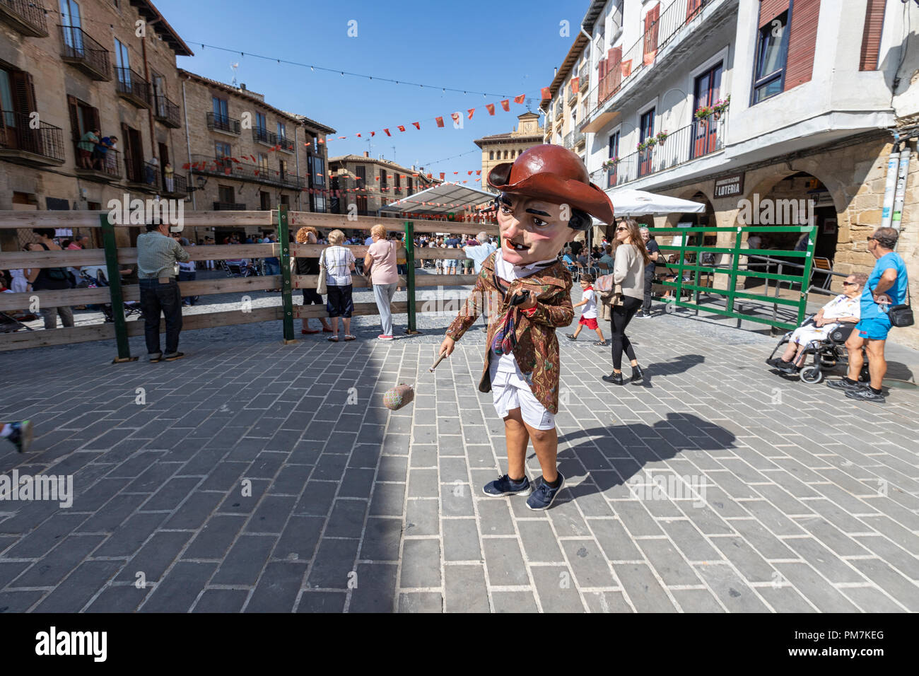 Cabezudos carrying a pig bladder, used to frighten children or young ...