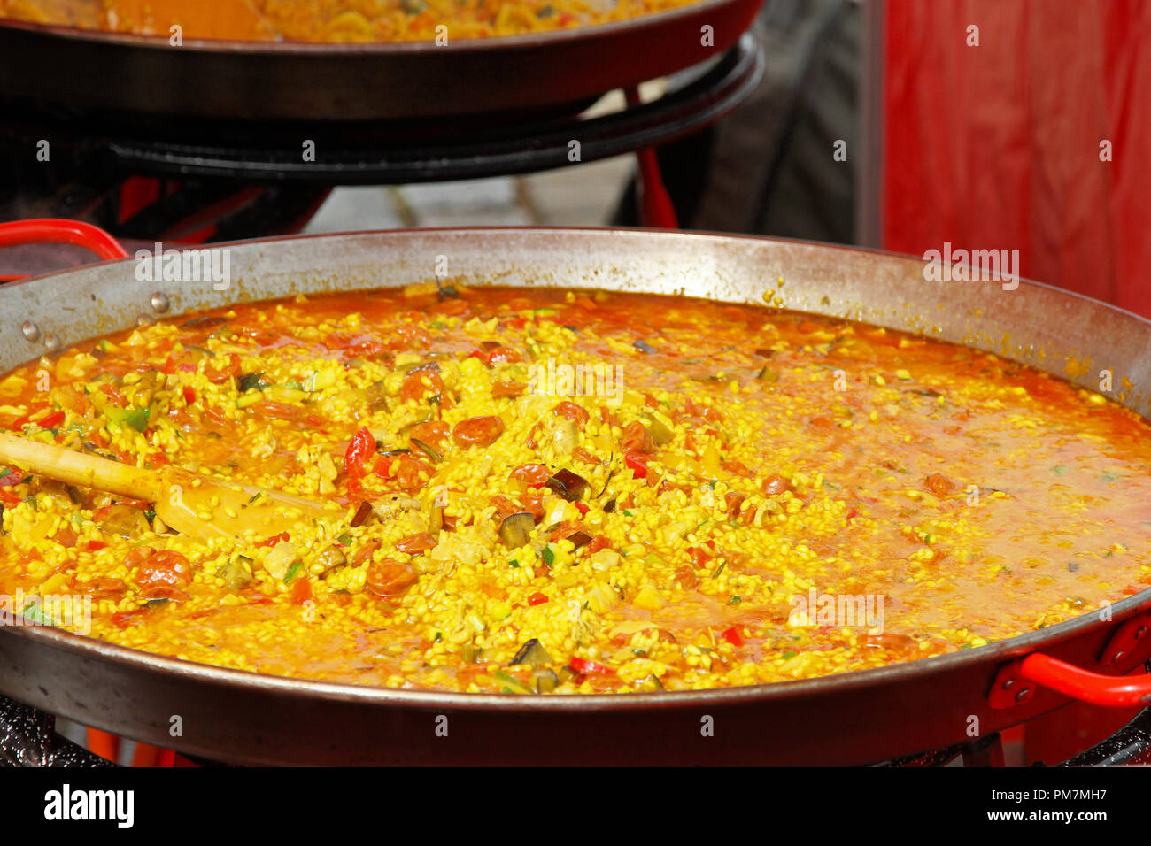 Big pot with tasty curry rise cooking inside Stock Photo - Alamy