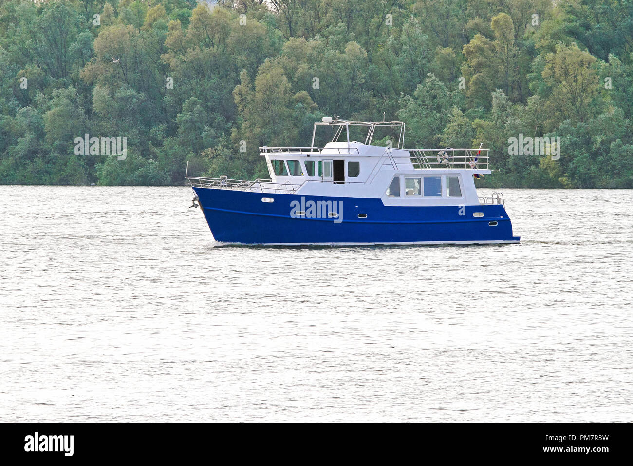 Blue Motor Boat Float at Big River Stock Photo - Alamy