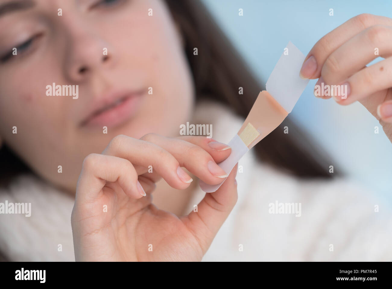 Woman using adhesive tape on hand Stock Photo - Alamy