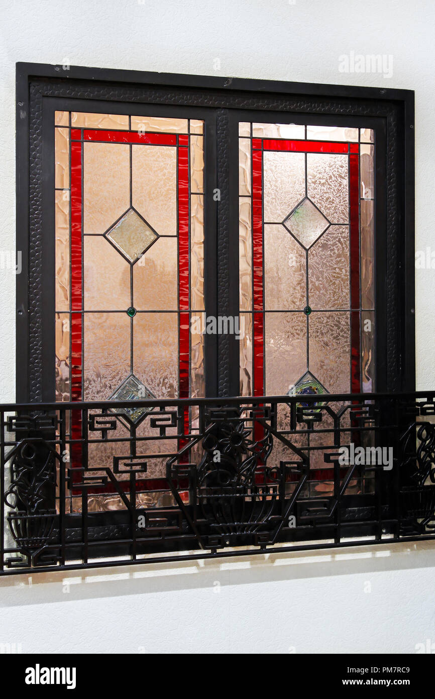 Colorful Stained Glass Window With Metal Fence Stock Photo - Alamy