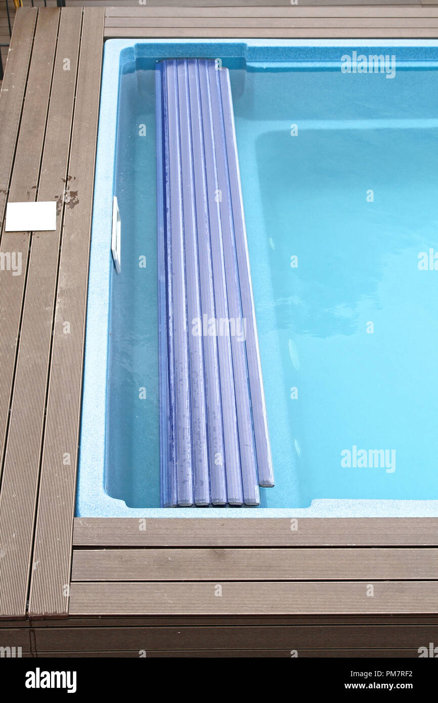 Automatic Swimming Pool Plastic Cover in Roll Stock Photo - Alamy