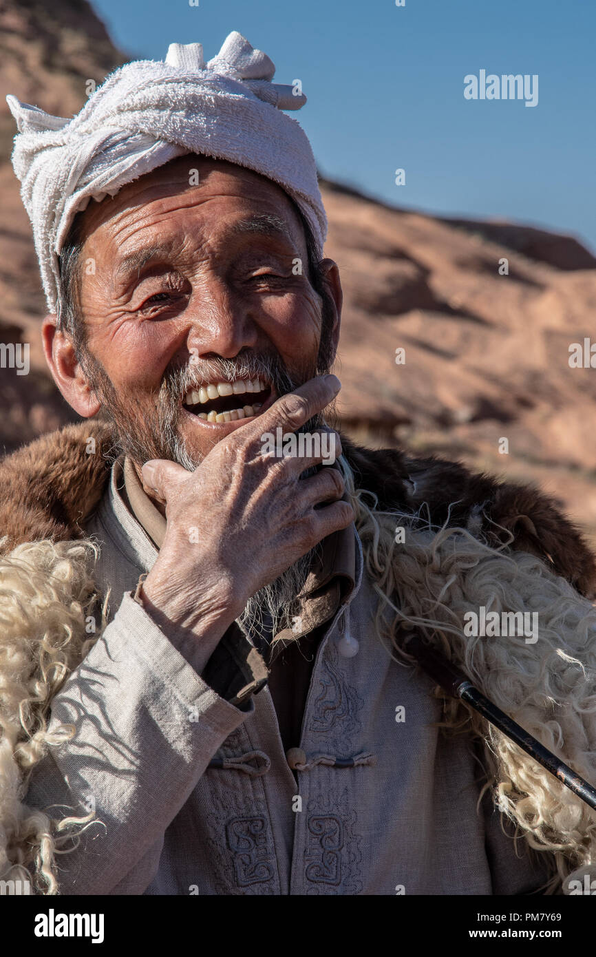 Smiling Chinese elder with traditional garb Stock Photo - Alamy