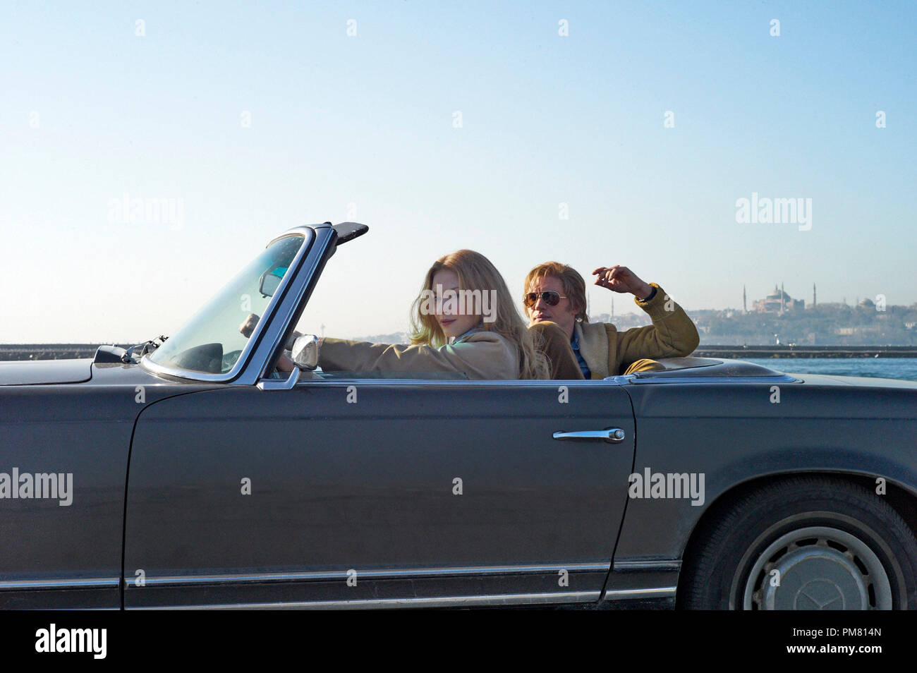 Svetlana Khodchenkova (L) as "Irina" and Tom Hardy (R) as "Ricki Tarr ...