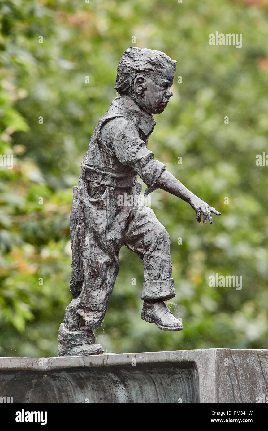 Metal sculpture, by Graham Ibbeson (of a boy running), on Abington ...
