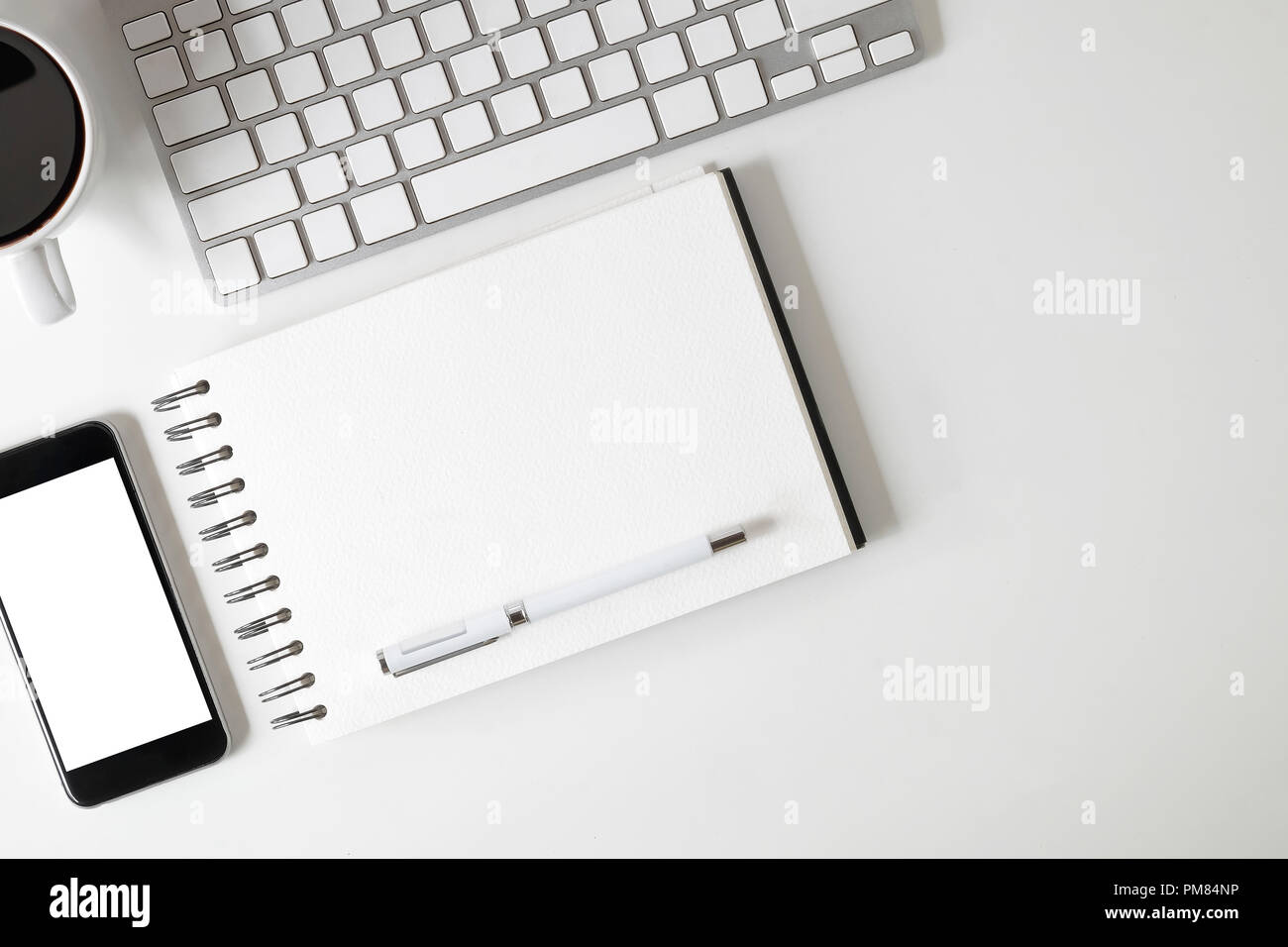 Mockup computer on workspace smartphone, pen, coffee, notebook and ...