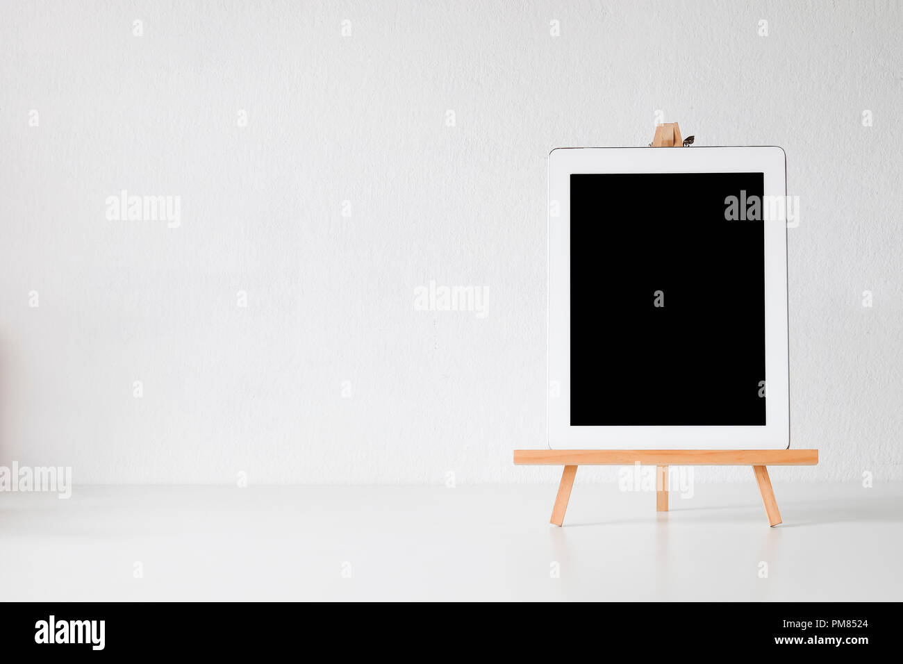Mockup digital tablet on wooden stand and white isolated background ...