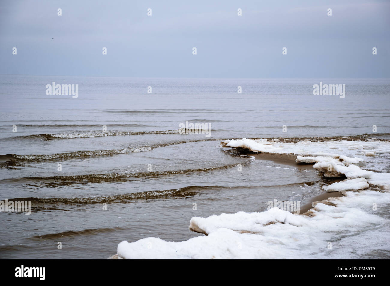 frozen dunes by the sea with ice water and snow on the beach sand Stock ...