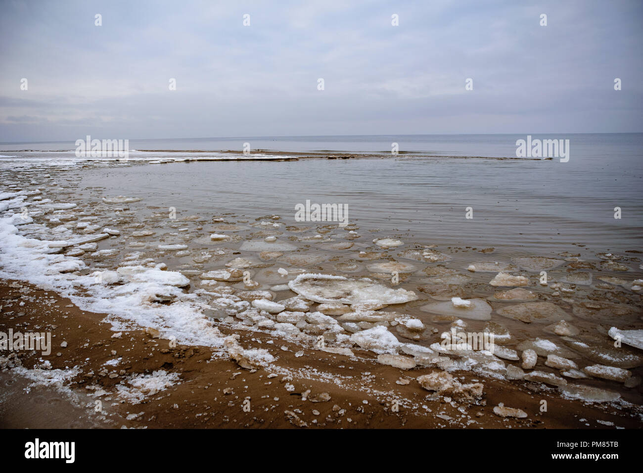 frozen dunes by the sea with ice water and snow on the beach sand Stock ...