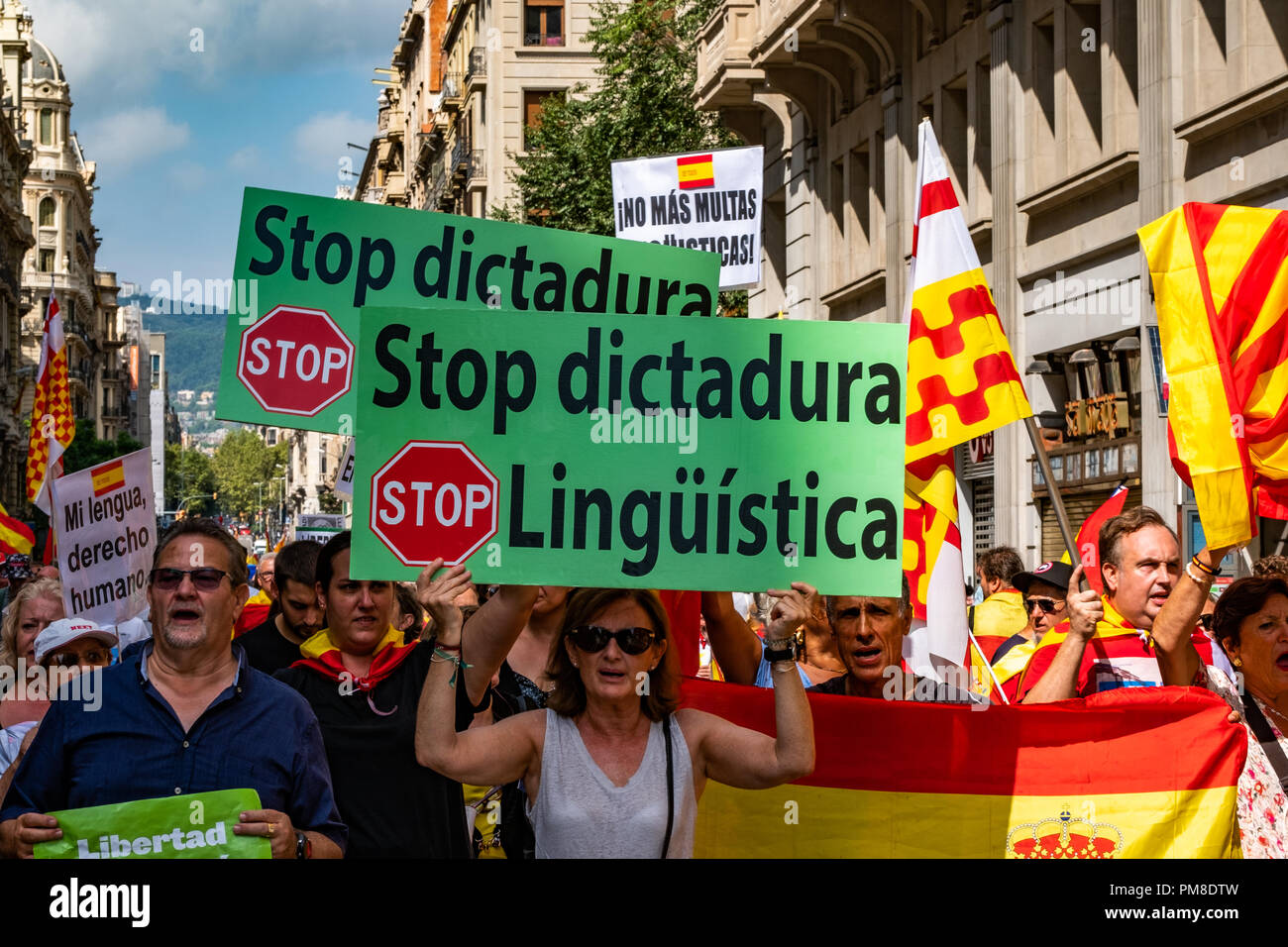 Several Spanish protesters seen displaying posters with the text STOP ...