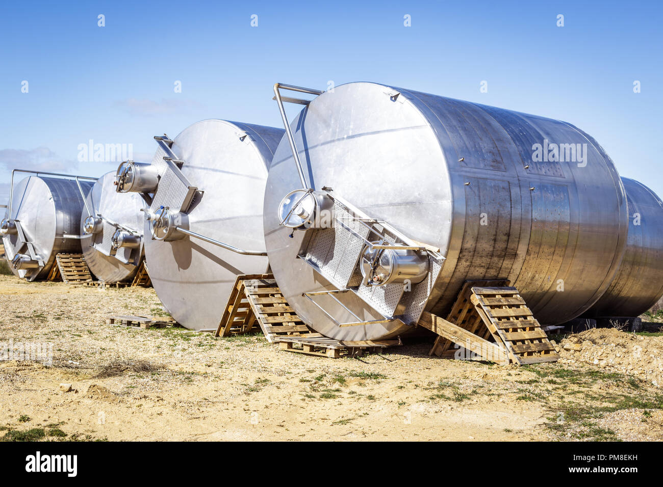Stainless steel wine vats in a row outside the winery Stock Photo - Alamy