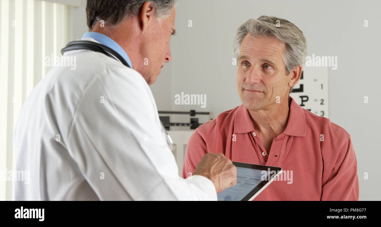 Senior doctor talking with old patient Stock Photo - Alamy