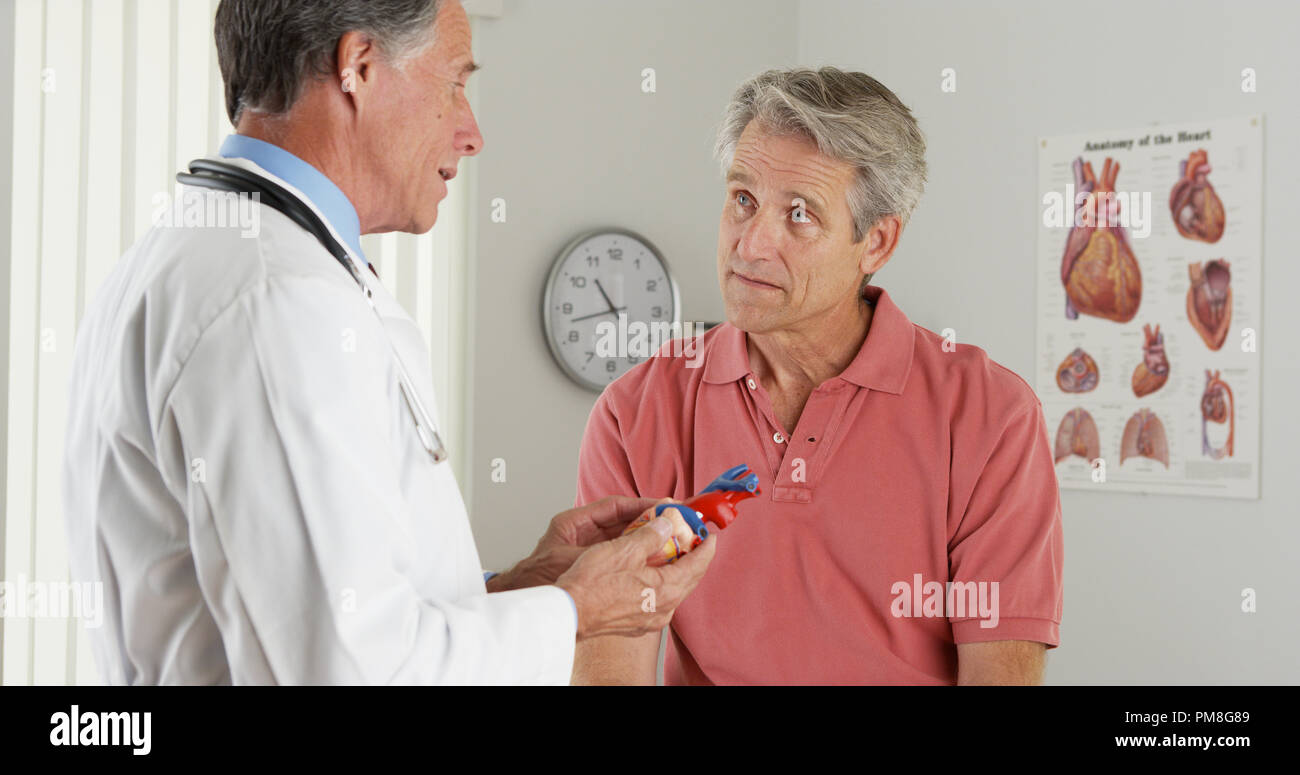 Doctor talking elderly patient heart hi-res stock photography and ...