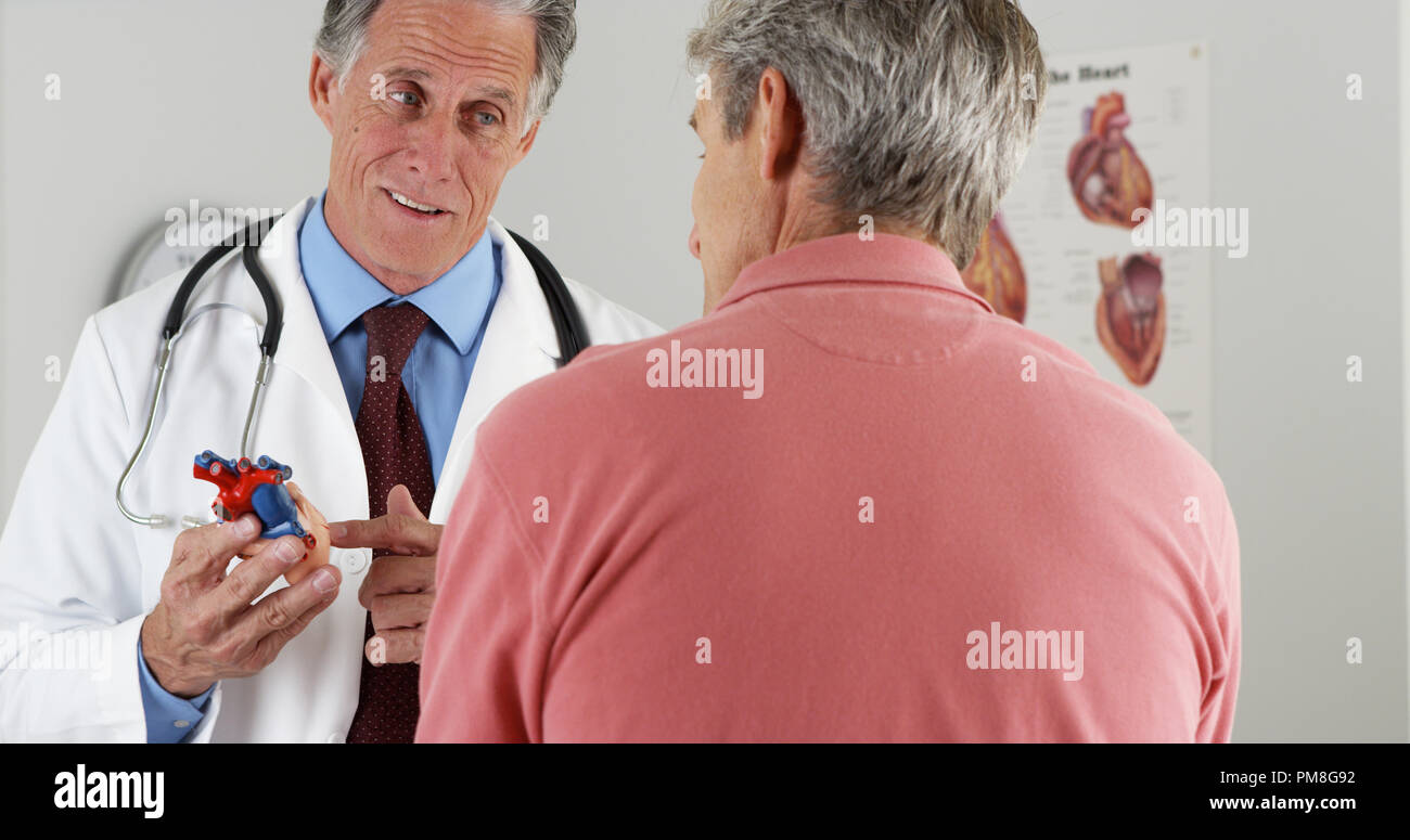 Cardiologist talking elderly patient heart hi-res stock photography and ...