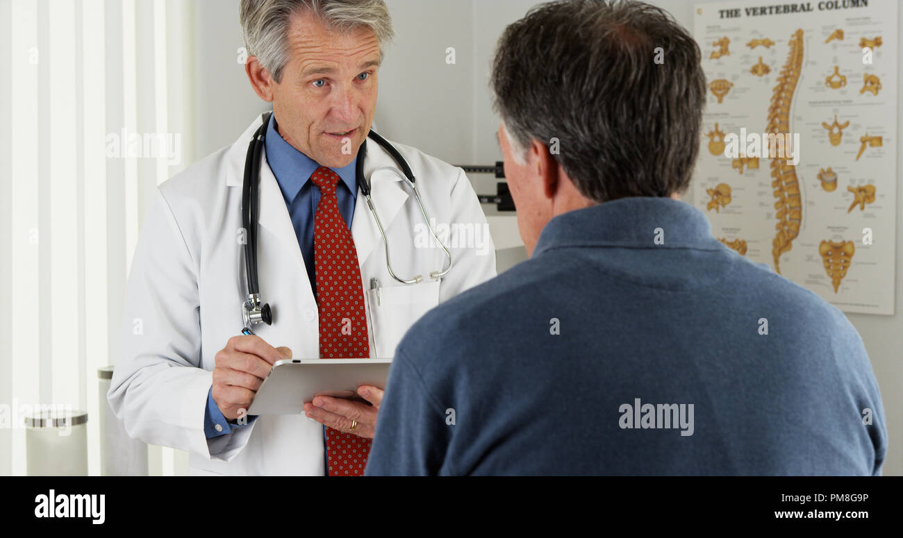 Doctor asking elderly patient questions in the office Stock Photo - Alamy