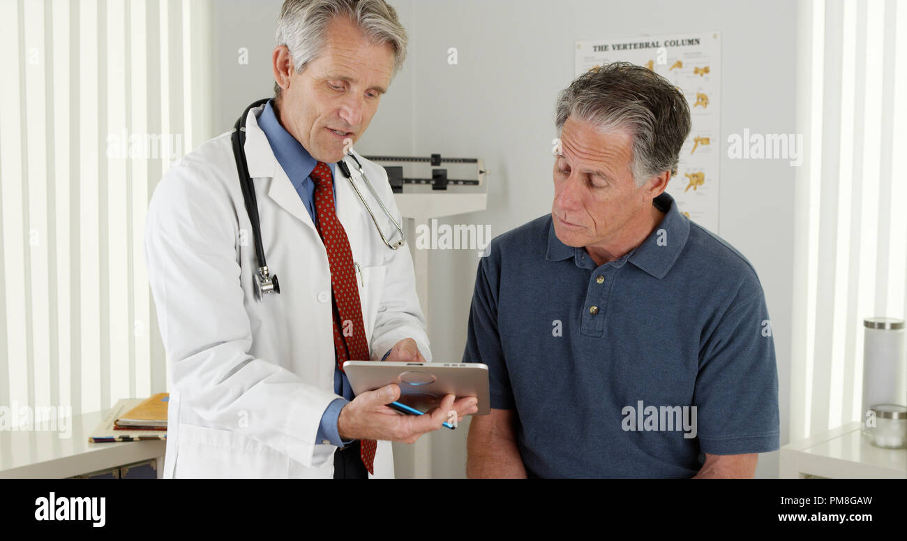 Doctor and patient talking in the office Stock Photo - Alamy