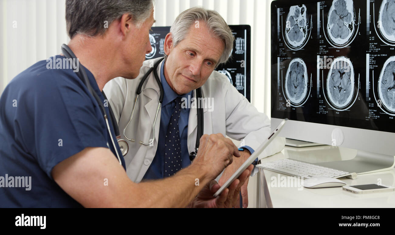 Team of experienced senior doctors working in the office Stock Photo ...