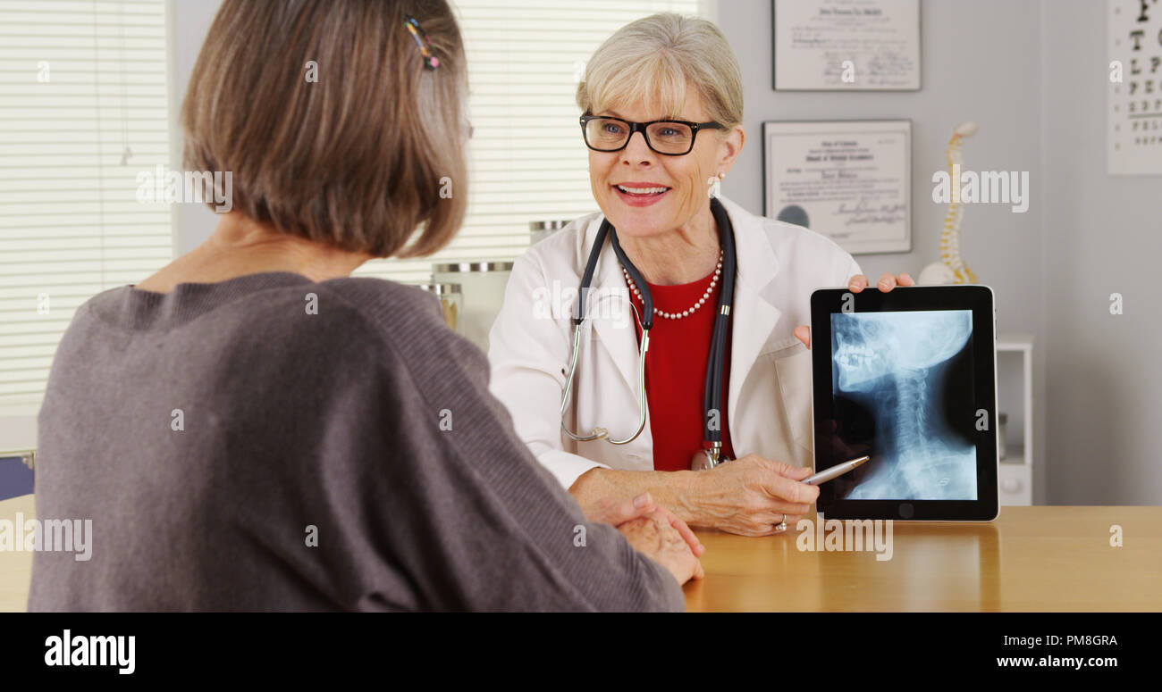 Senior doctor tablet talking hi-res stock photography and images - Alamy