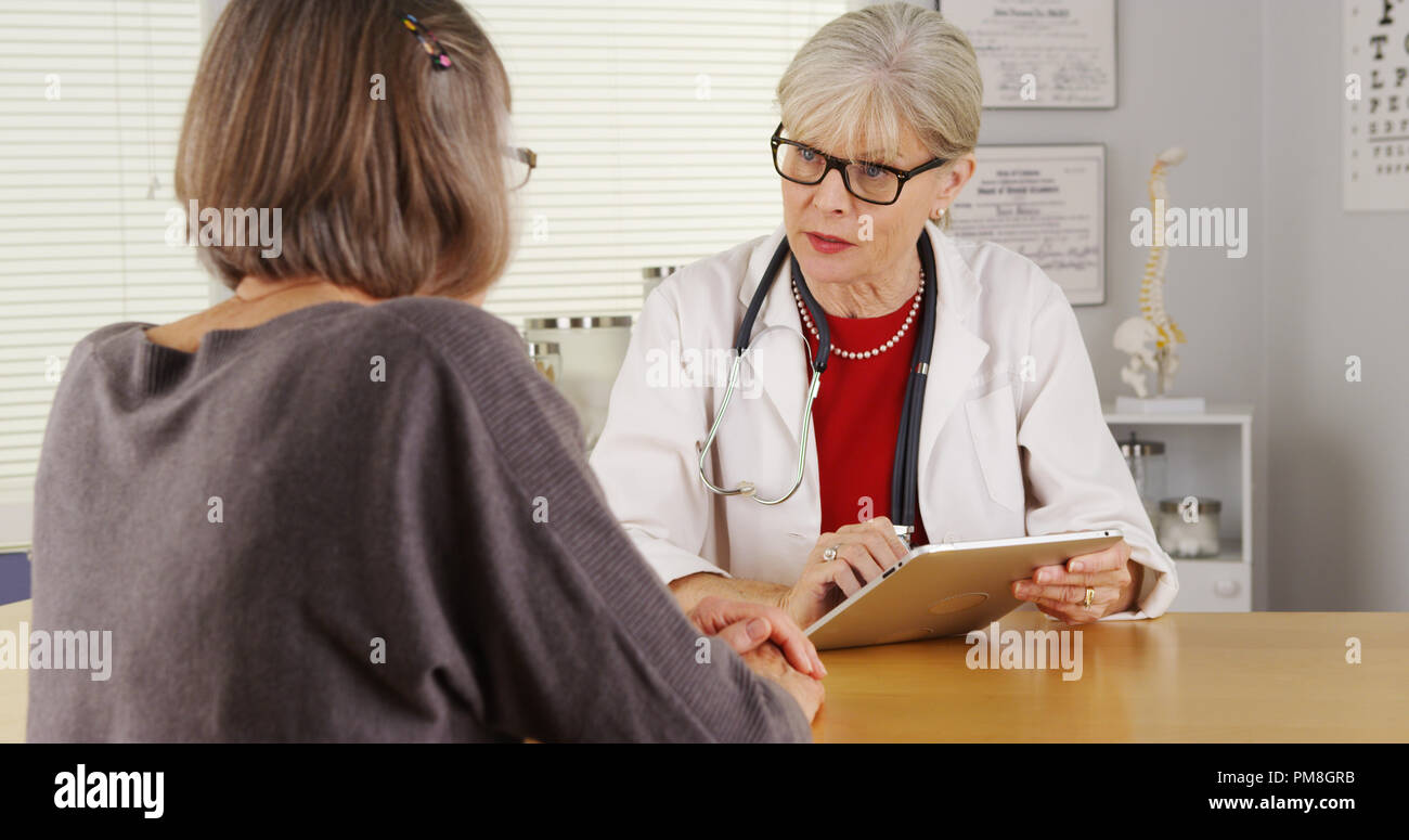 Happy women doctor desk patient hi-res stock photography and images - Alamy
