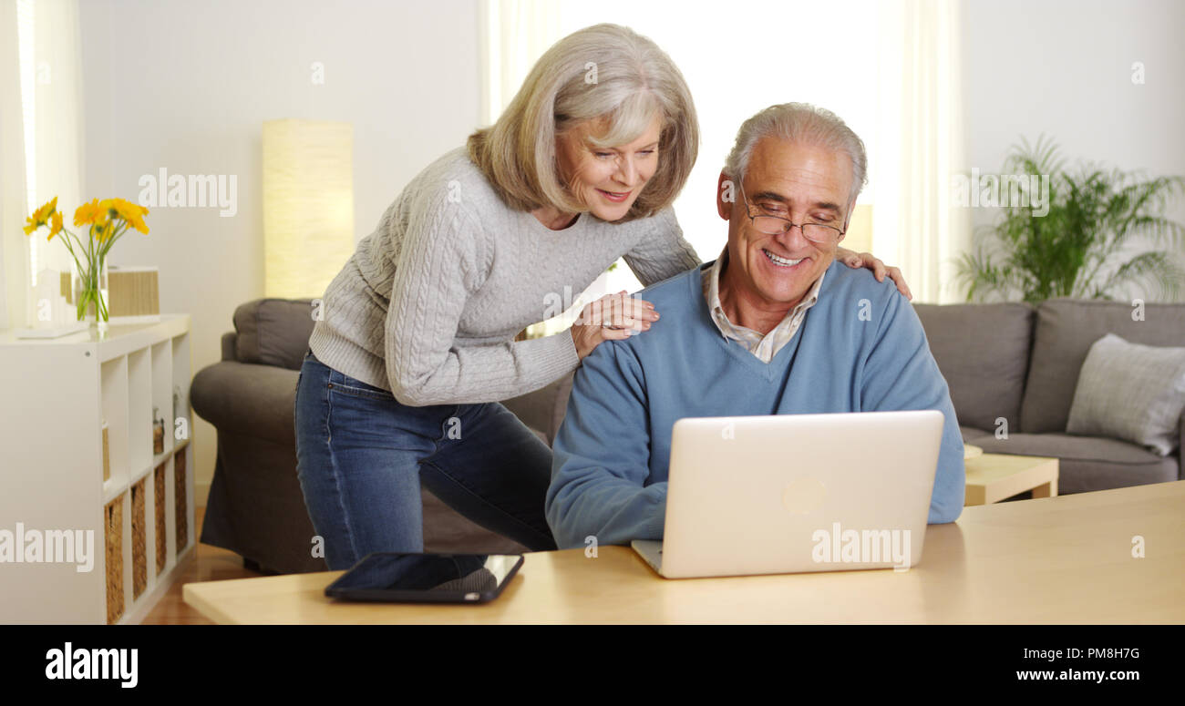 Senior adults using laptop computer at desk Stock Photo - Alamy