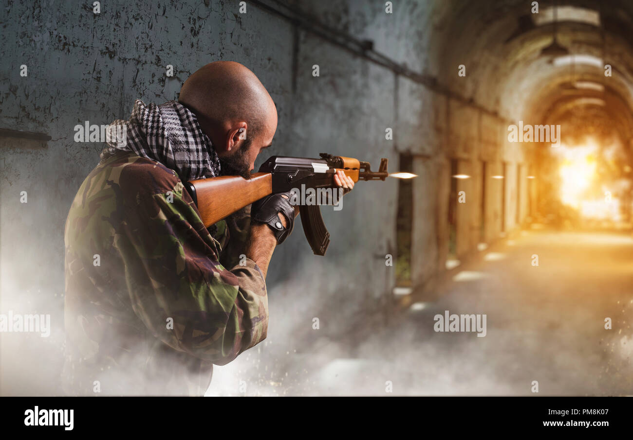 Bearded terrorist shoots from a rifle, explosion and fire at the end of ...
