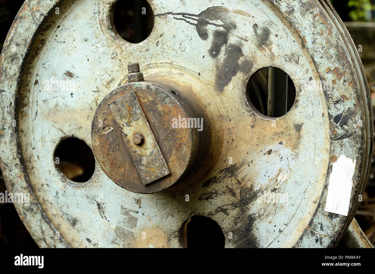 A old rusty pulley wheel in the factory Stock Photo - Alamy