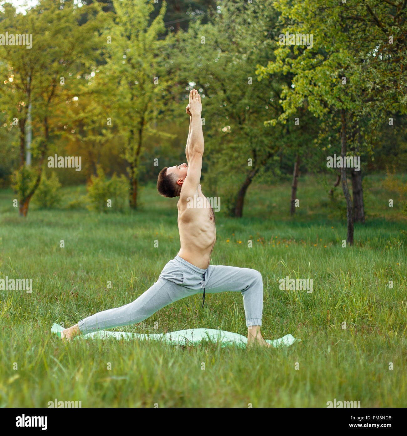 Young man doing yoga hi-res stock photography and images - Alamy