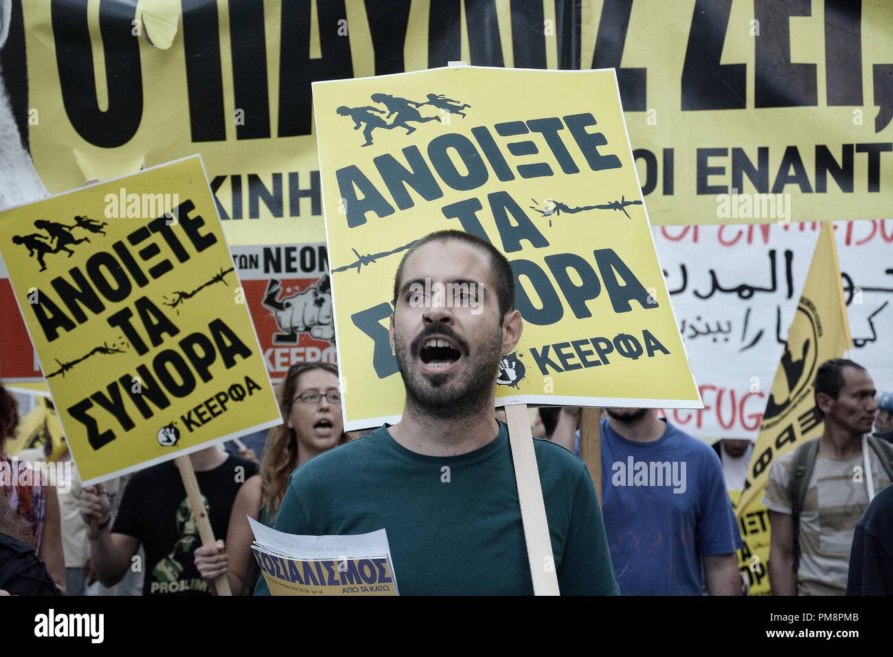 Protesters holding placards seen at the antifascist march in Athens ...