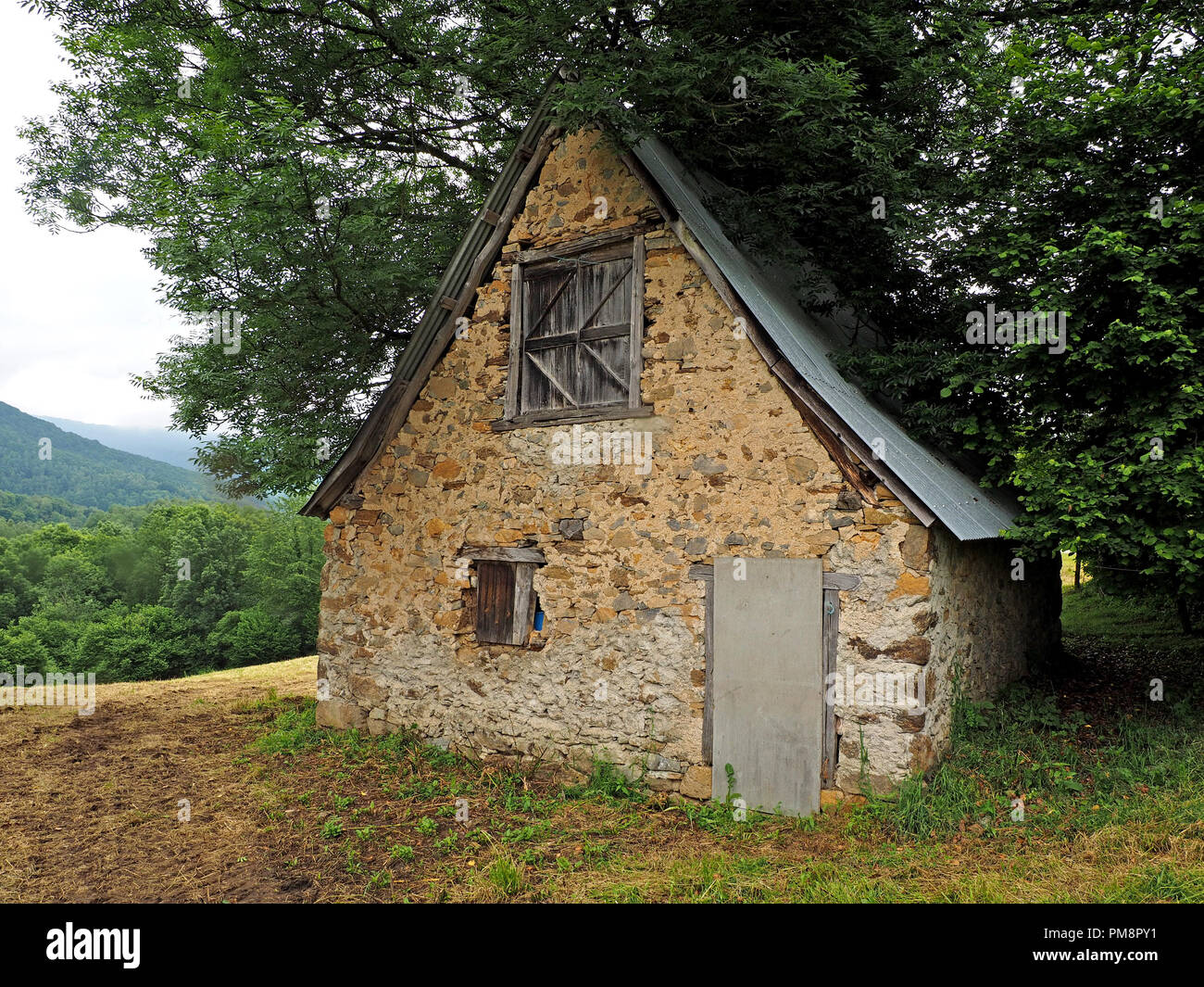 shades of brown in rustic stone and timber building with shuttered ...