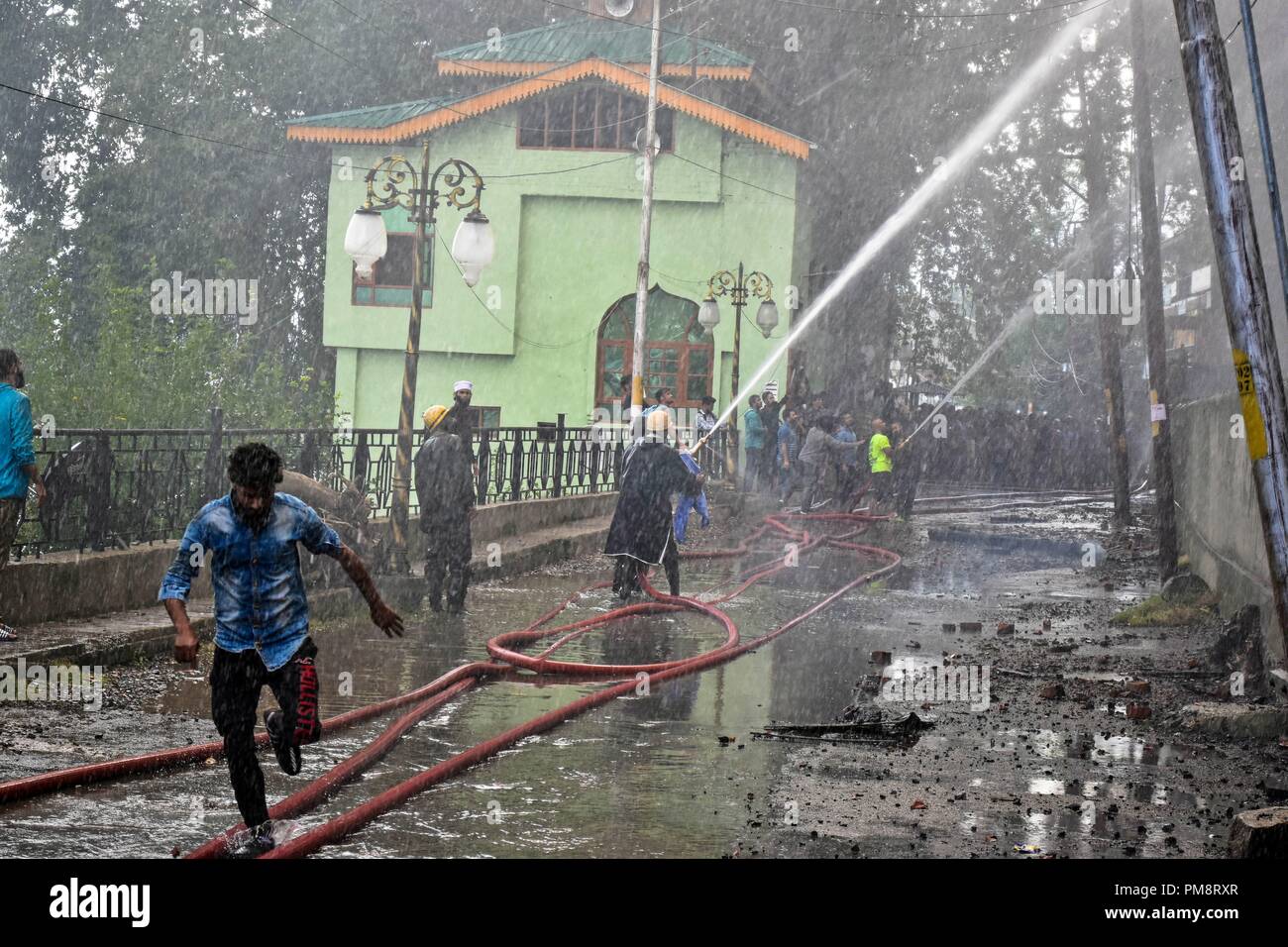 Locals and firefighters seen trying to extinguish the fire. A massive ...