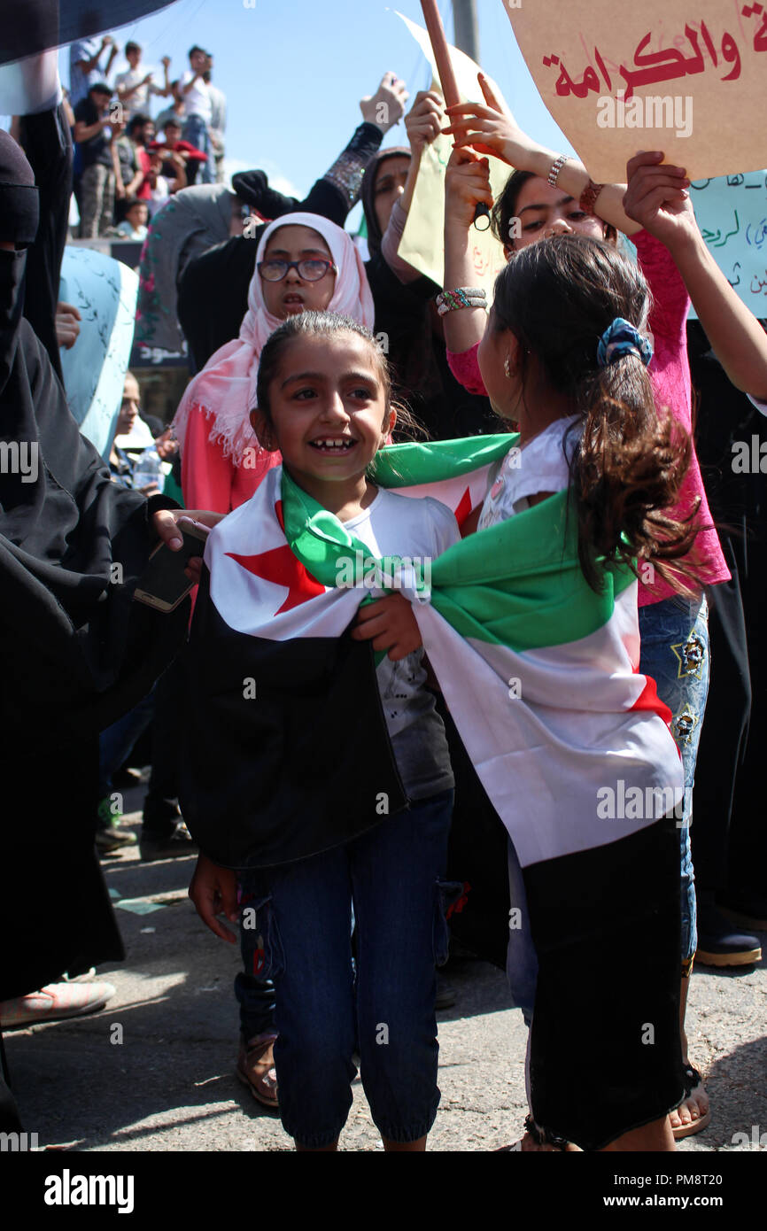Two young girls seen tied together by a flag during the protest against ...